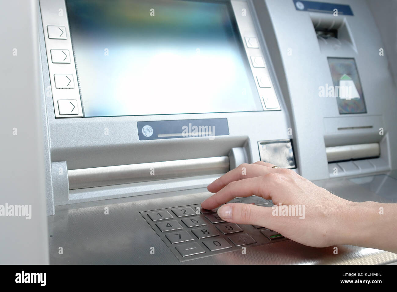 Closeup of woman's hand entering PIN code on ATM machine keypad Stock ...