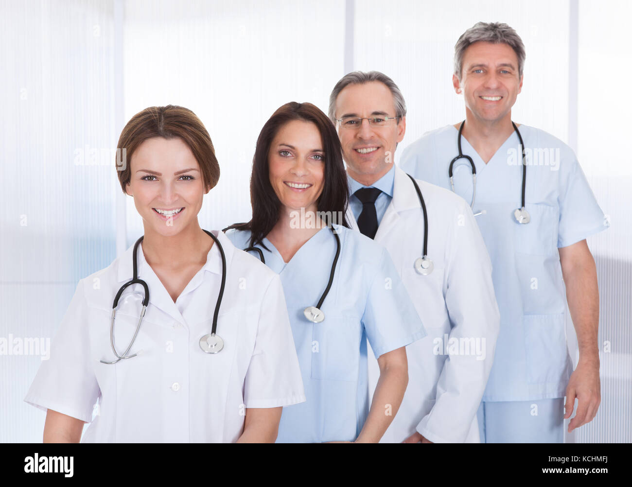 Group Of Happy Doctor Standing In A Row Together Stock Photo - Alamy