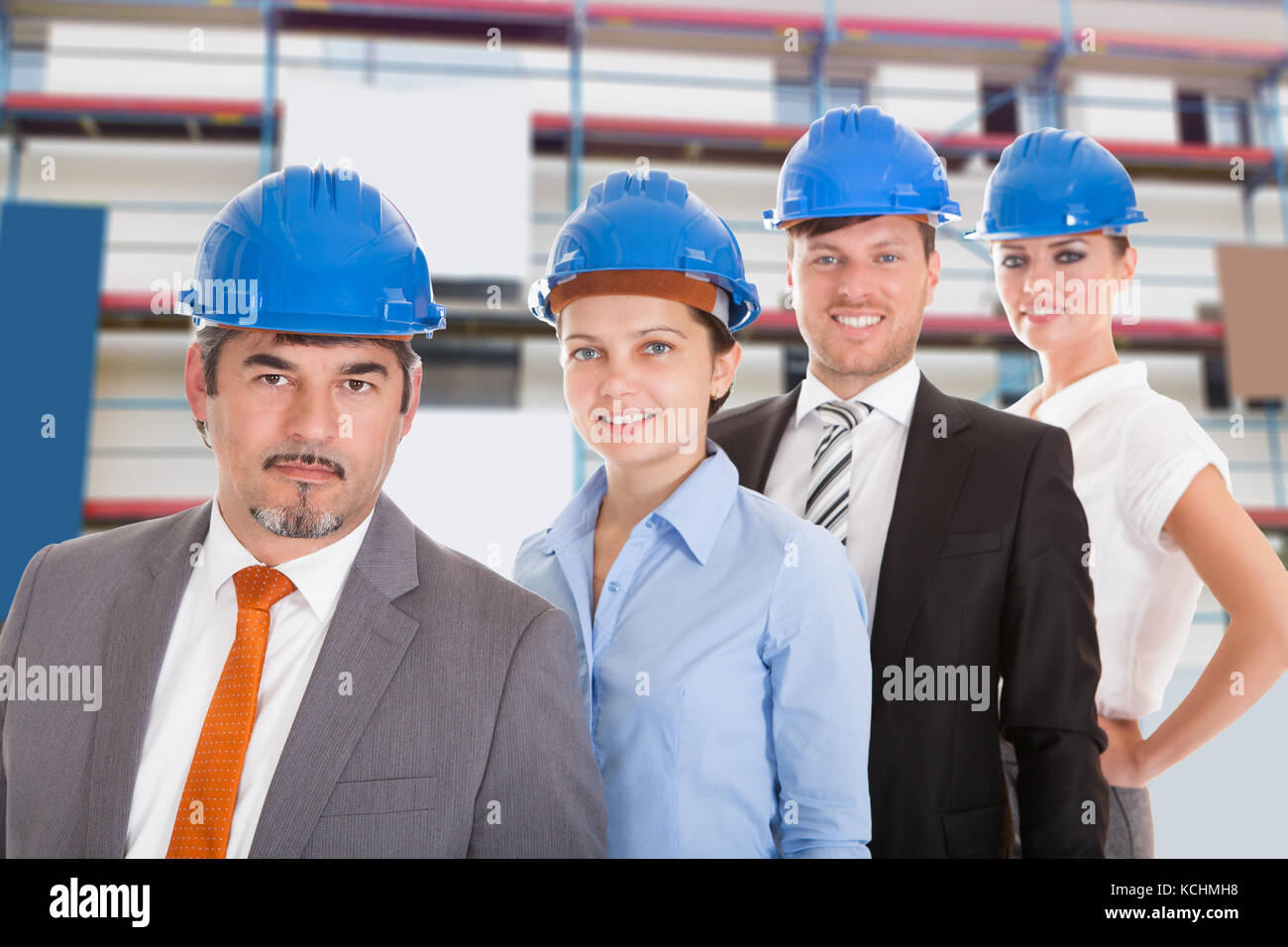Portrait Of Happy Architects Wearing Helmet And Standing In A Row Stock ...