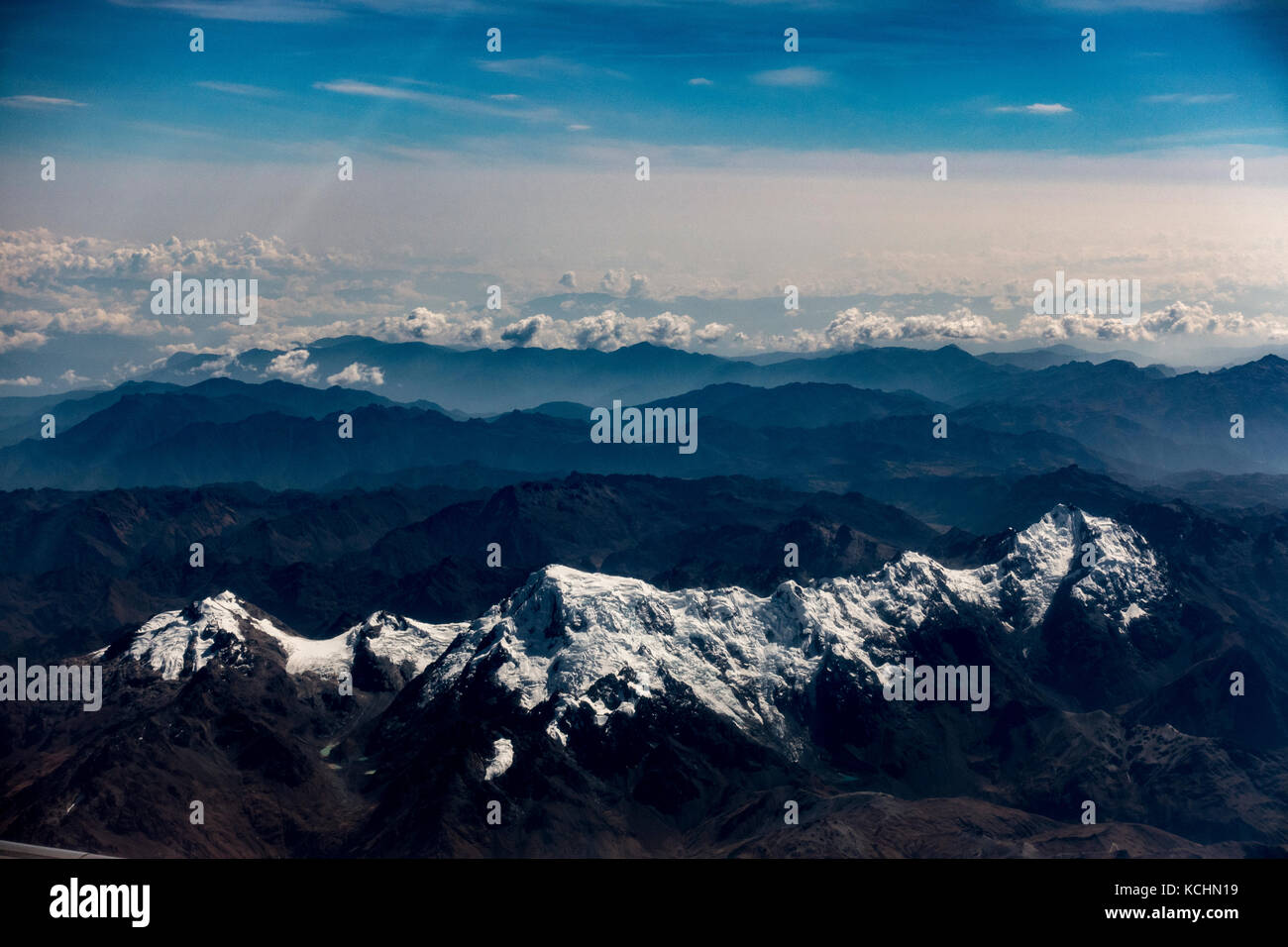 An aerial view of the snow capped Peruvian Andes, shot from an airplane ...