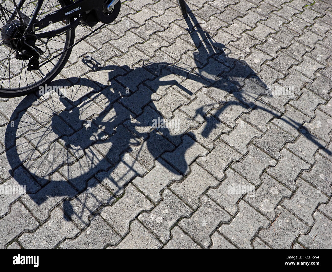 Shadow of a bicycle on block paving in Tuscany, Italy Stock Photo - Alamy