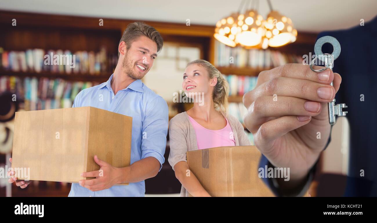 Digital composite of people moving boxes into new home with key Stock ...