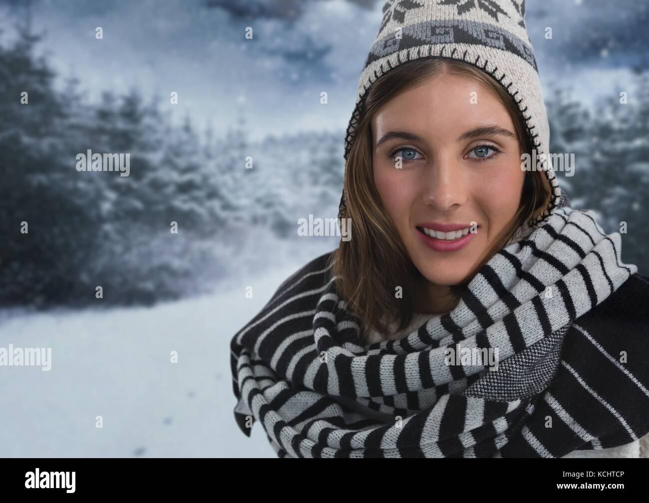 Digital composite of Woman with scarf and hat in snow forest at night ...