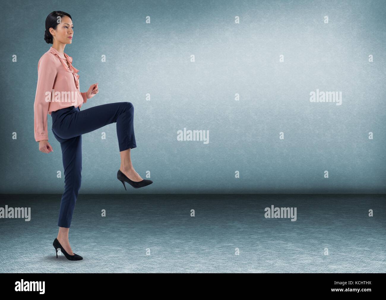 Digital composite of Businesswoman standing on one foot in room Stock ...