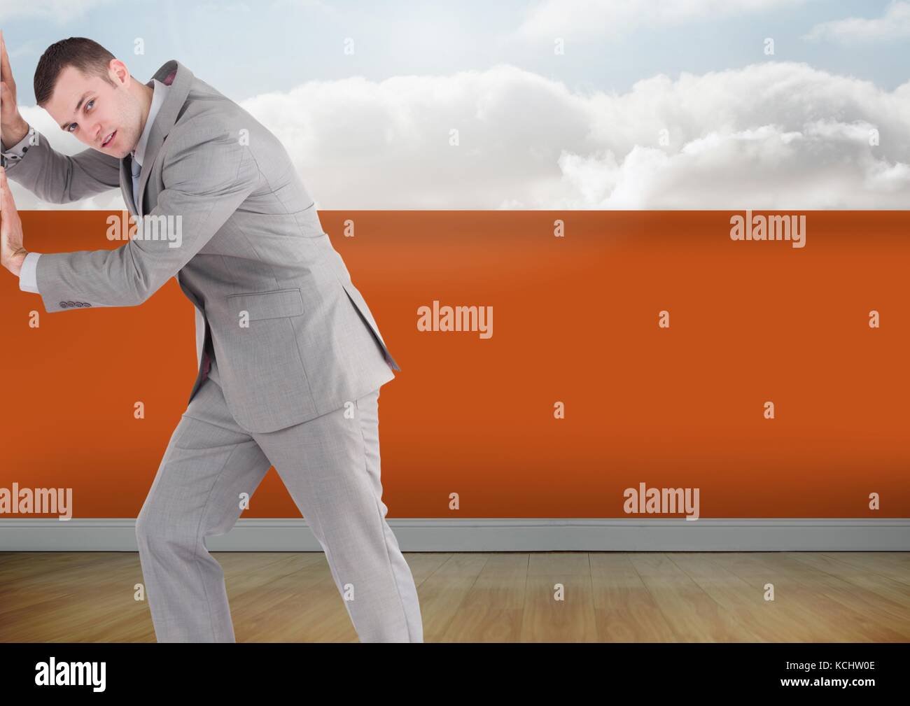 Digital composite of Businessman with orange wall pushing Stock Photo ... Digital composite of Businessman with orange wall pushing Stock Photo ...