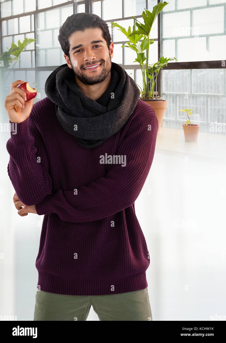 Digital composite of Man eating apple by windows Stock Photo - Alamy