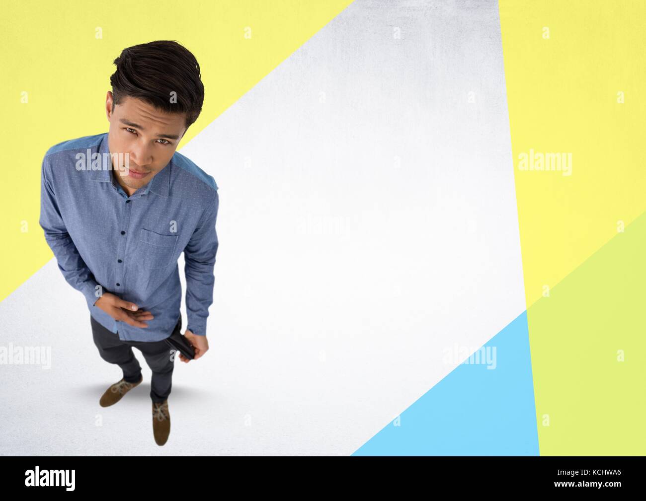 Digital composite of Businessman looking up in strange perspective with ...