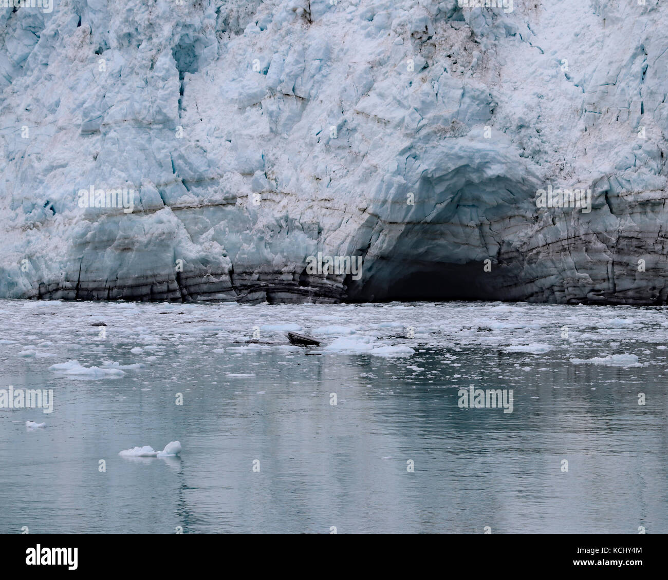 Closeup of the Margerie glacier where it enters the water and caves ...