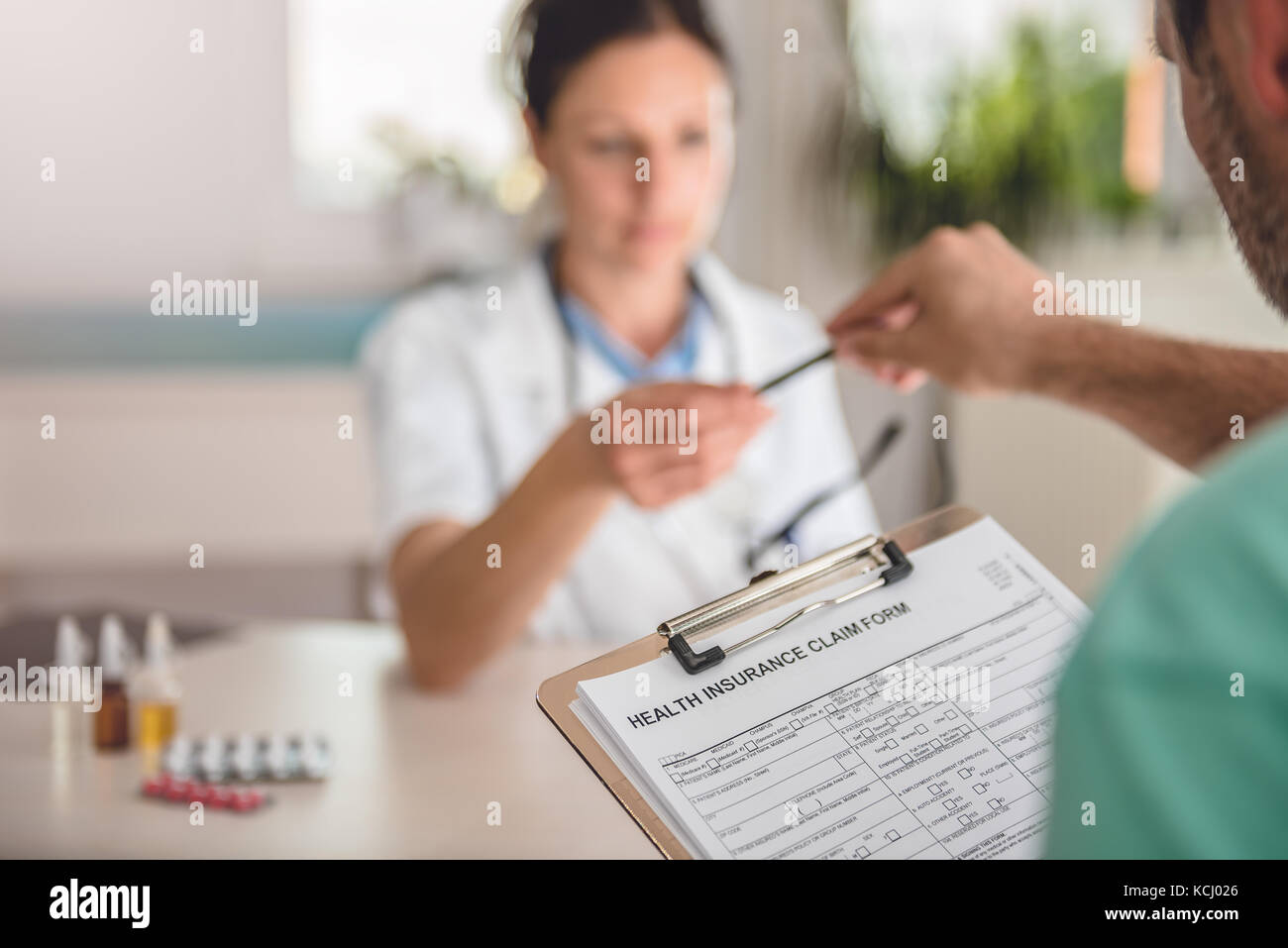 Patient filing health insurance claim form in the doctors office Stock ...