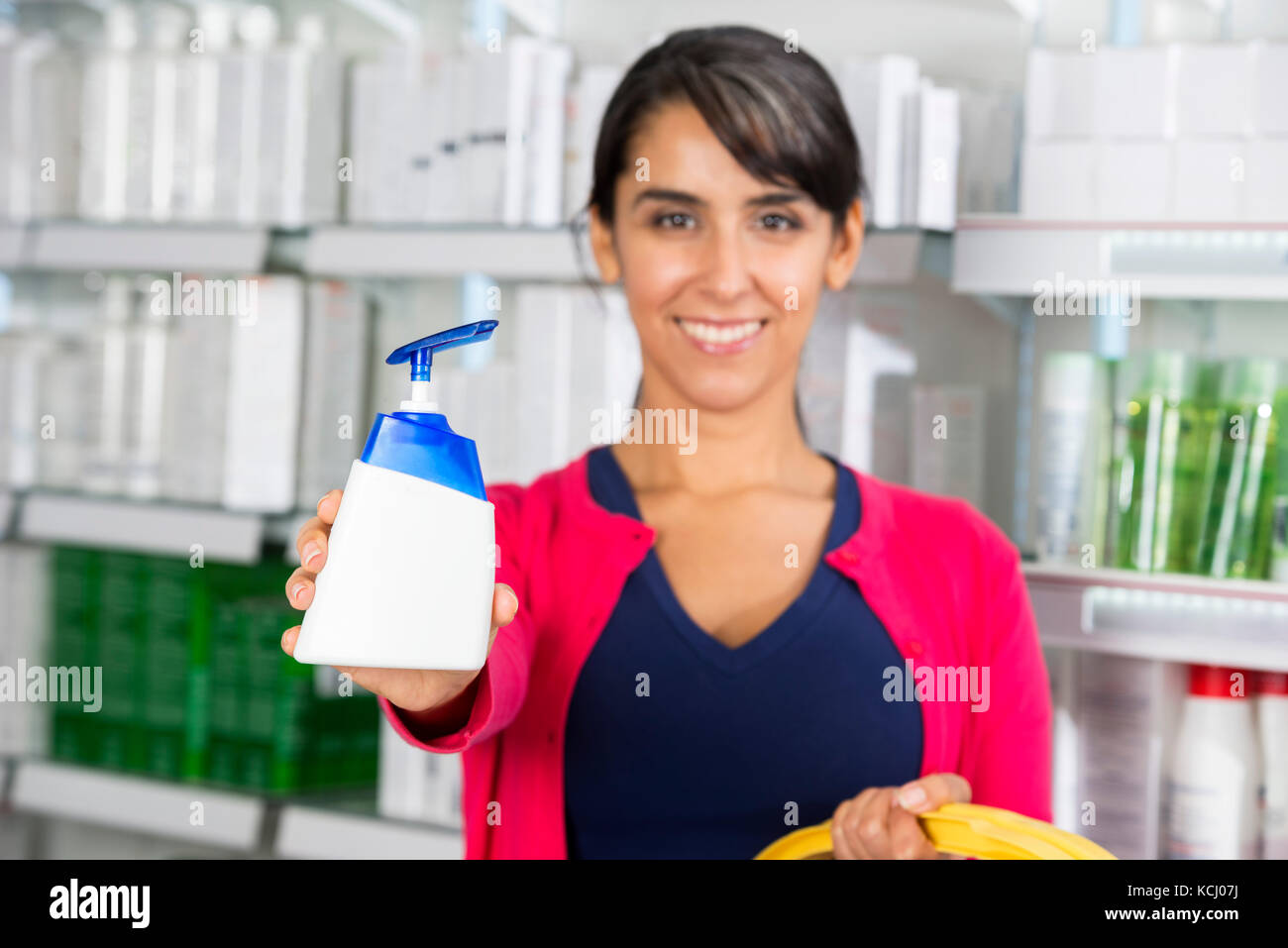 Woman Smiling While Showing Soap Dispenser In Pharmacy Stock Photo - Alamy