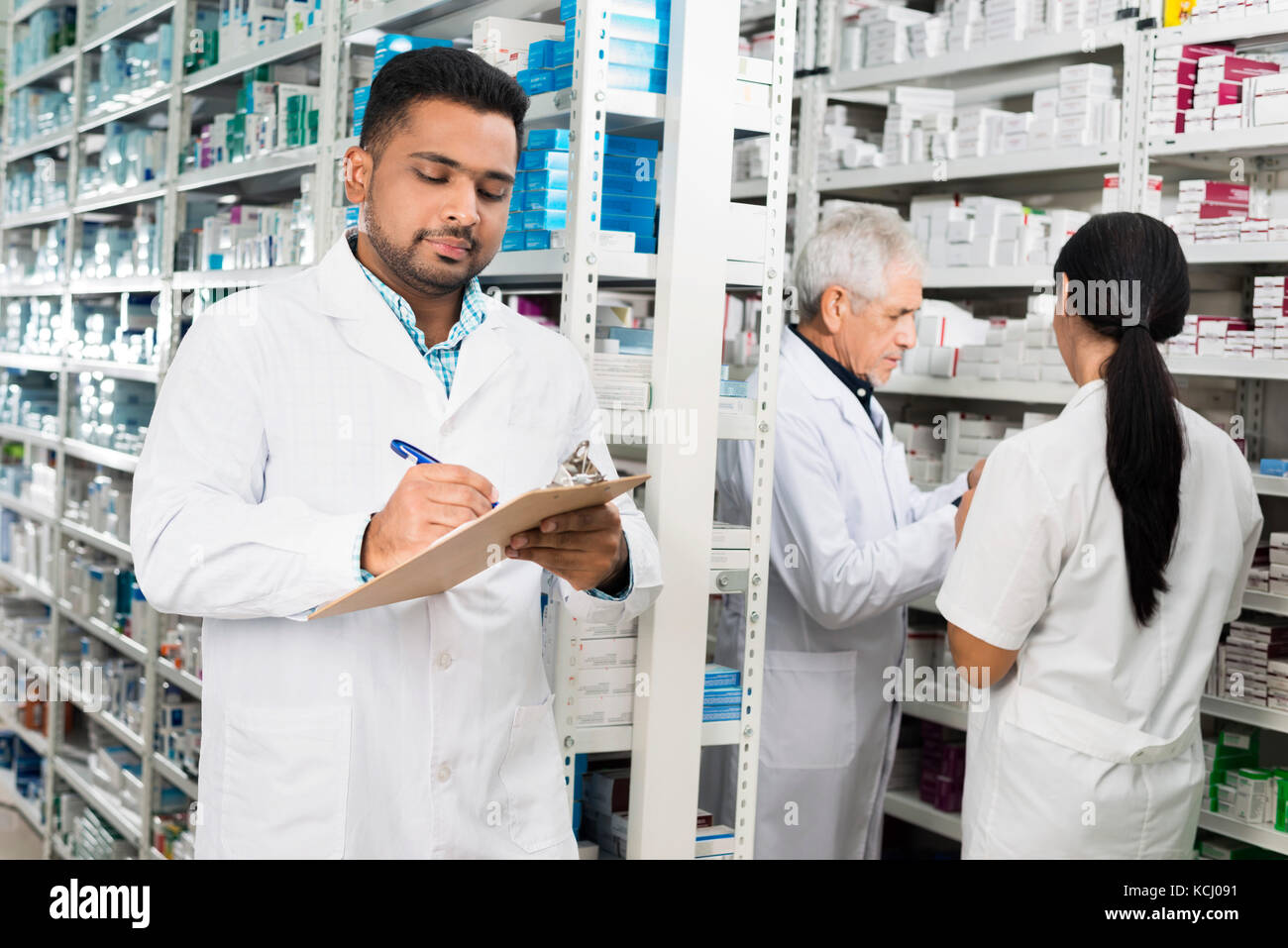 Chemist checking drugs shelf hi-res stock photography and images - Alamy