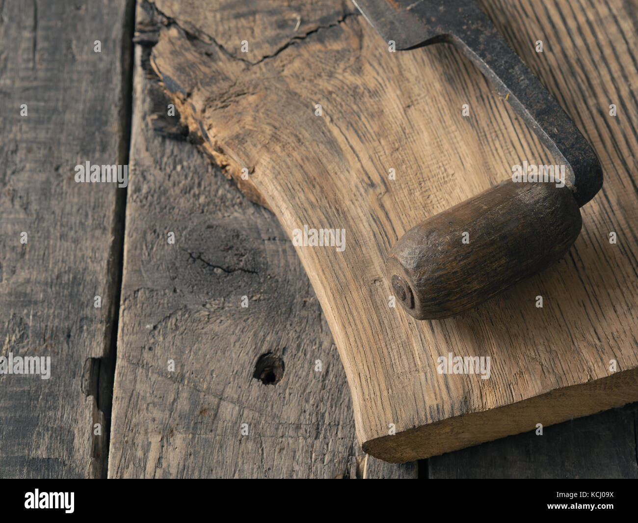 Old wood plane on a rustic oak plank, wood working or carpentry ...