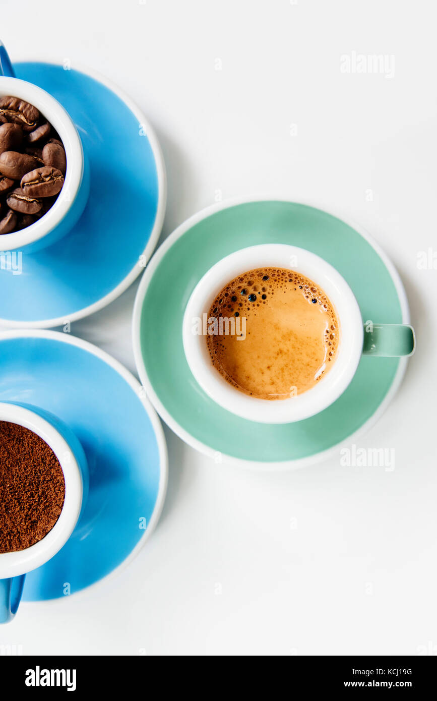 Three cups of coffee: ground coffee (powder), coffee beans and freshly ...