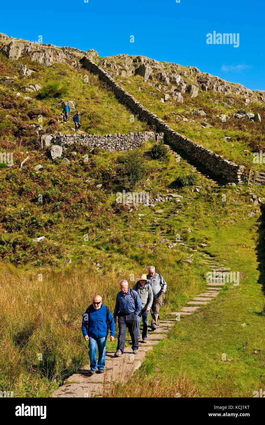 Group of walkers on a path footpath people walking descending Steel ...