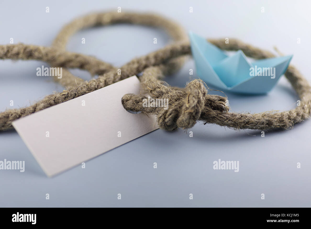 sticker with thick braided rope and ship paper origami Stock Photo - Alamy