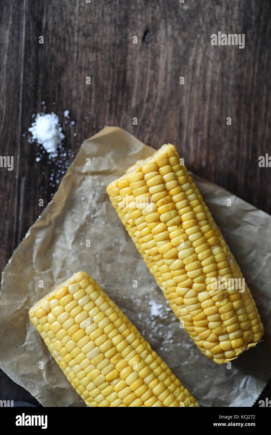 Boiled corn cob with salt on a wood Stock Photo - Alamy