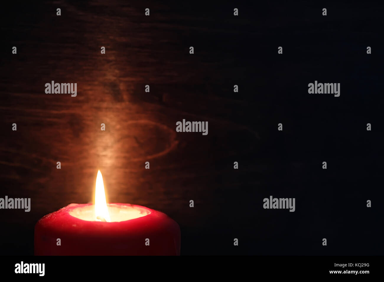 Burning candle flame in the dark Stock Photo - Alamy