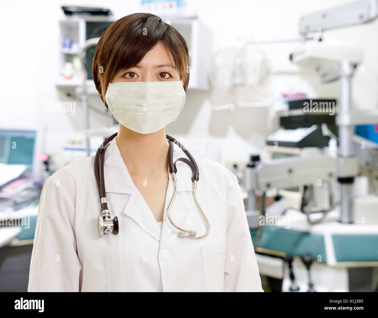 Chinese female doctor with stethoscope and surgical mask in clinic lab ...