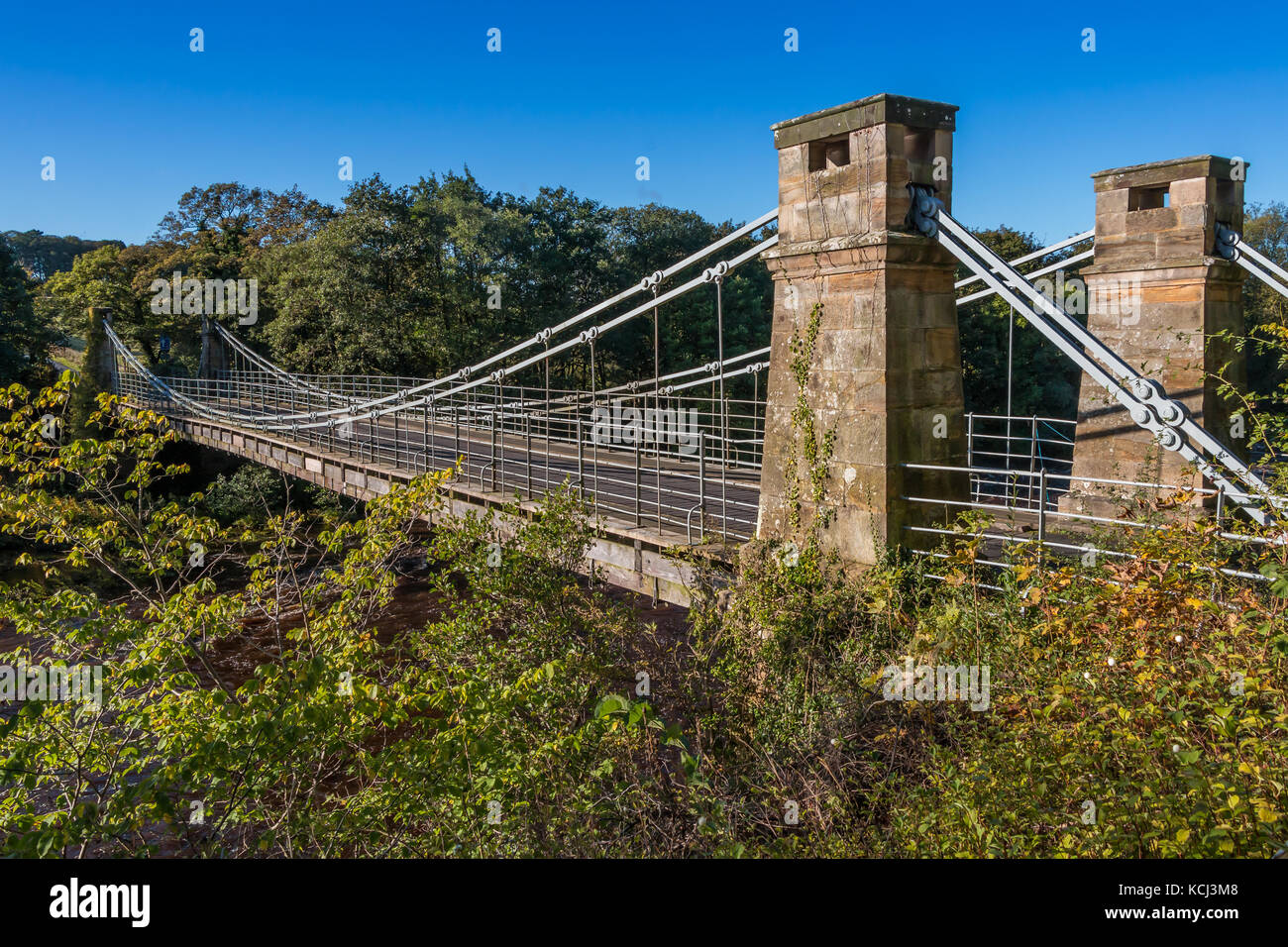 The 19th century suspension bridge over the river Tees at Whorlton ...