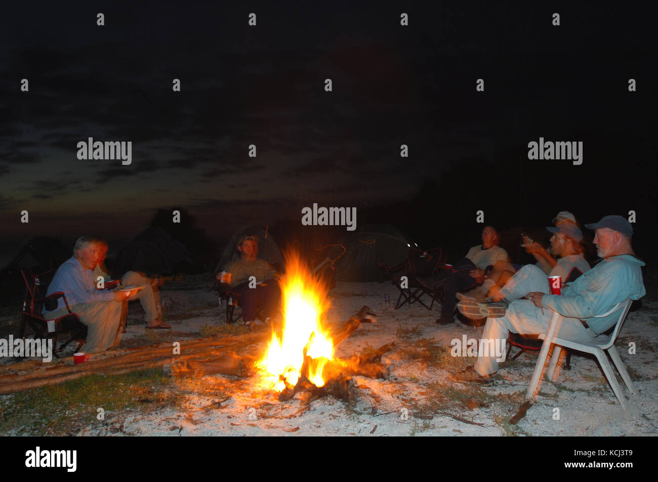 Fishermen camping on a remote beach at sunset while fly fishing for ...