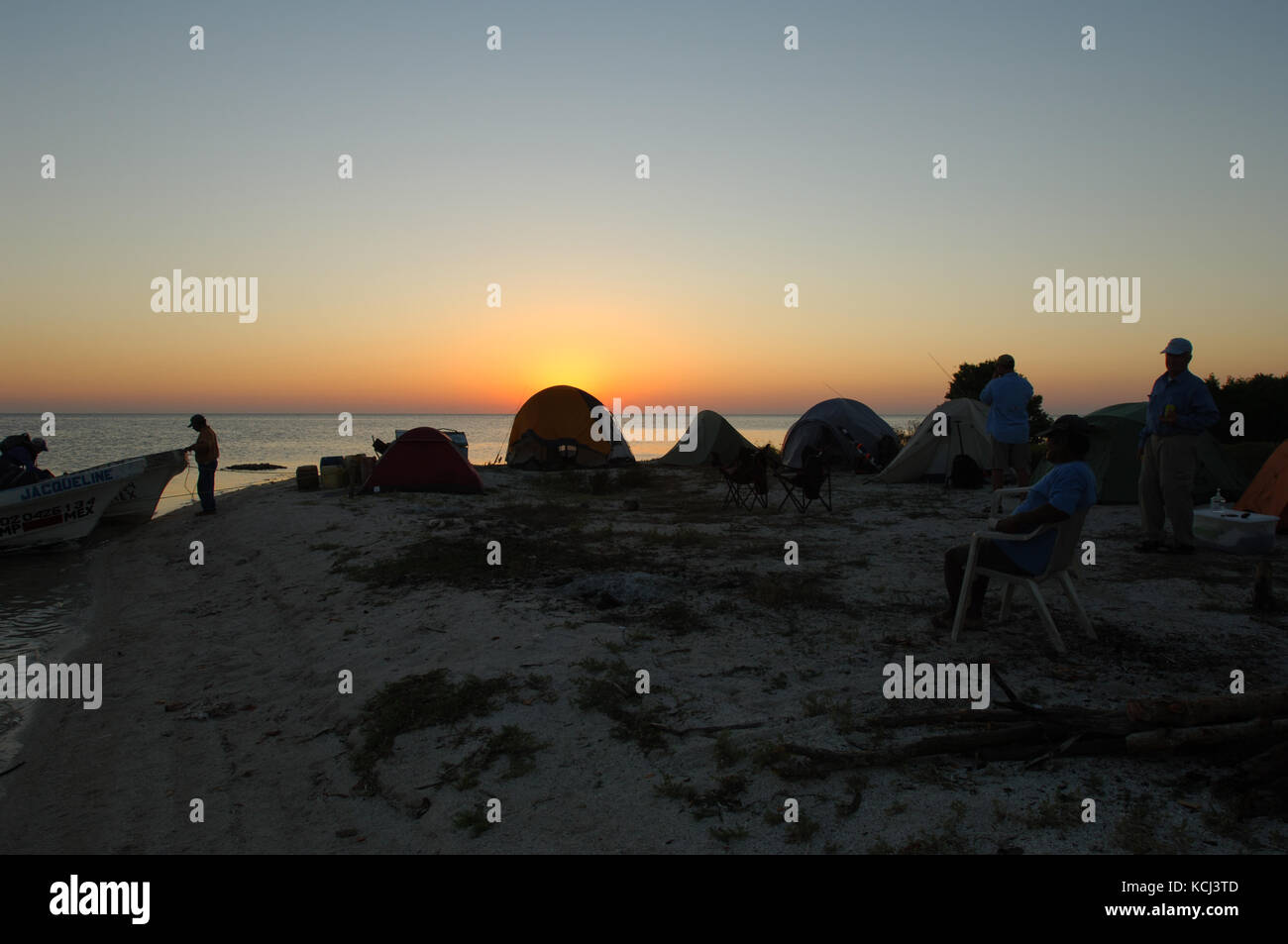 Fishermen camping on a remote beach at sunset while fly fishing for ...