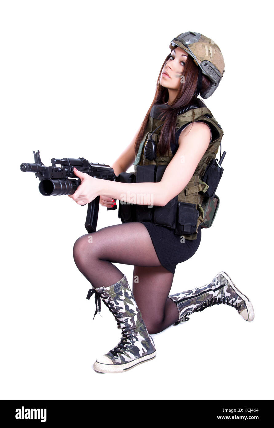 Woman in a military camouflage sitting with the assault rifle isolated ...