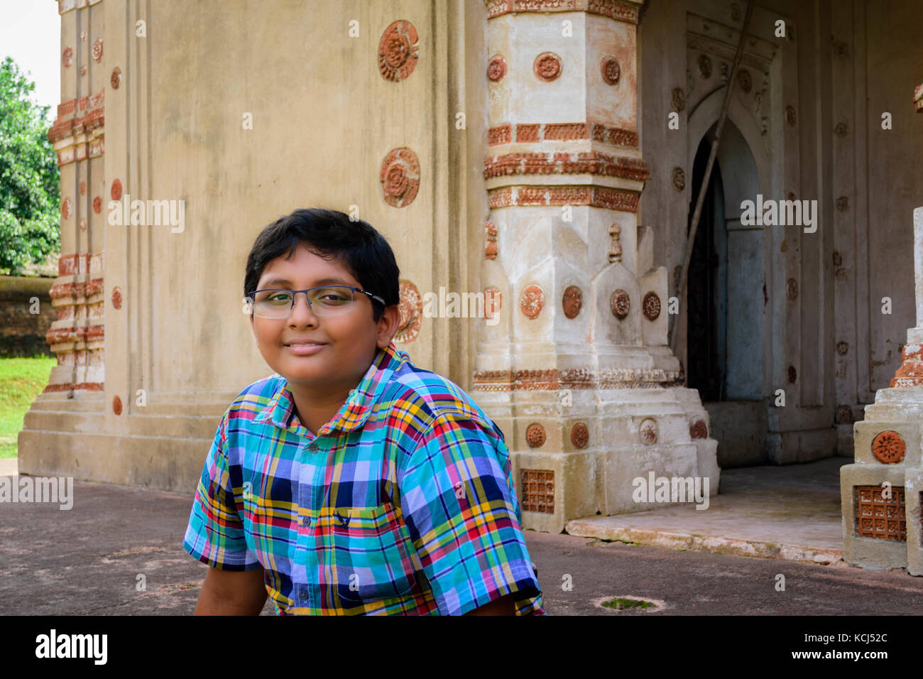 Young Bengali boy in front of Ancient Hindu terracotta temples of ...