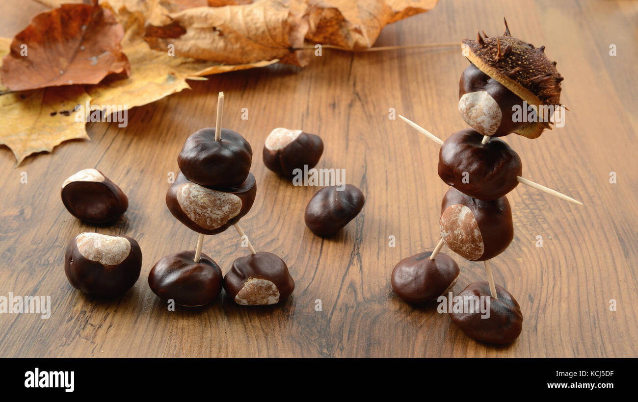 thinker chestnut figures in autumn time with thooth sticks Stock Photo ...