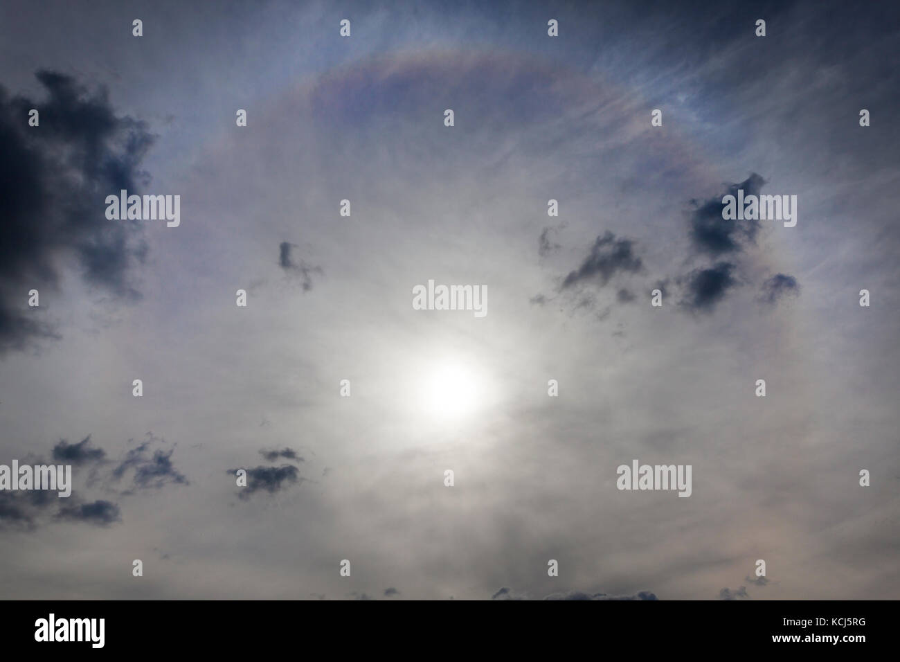 A beautiful solar halo in cloudy weather. photo close-up of the sun and ...