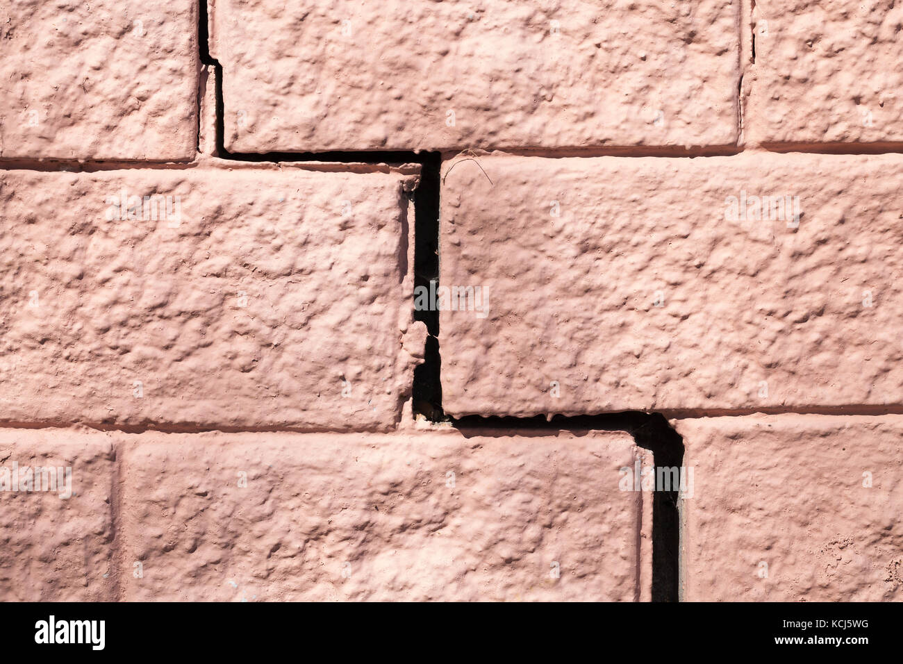 crack between large painted bricks. photo close-up of part of a ...