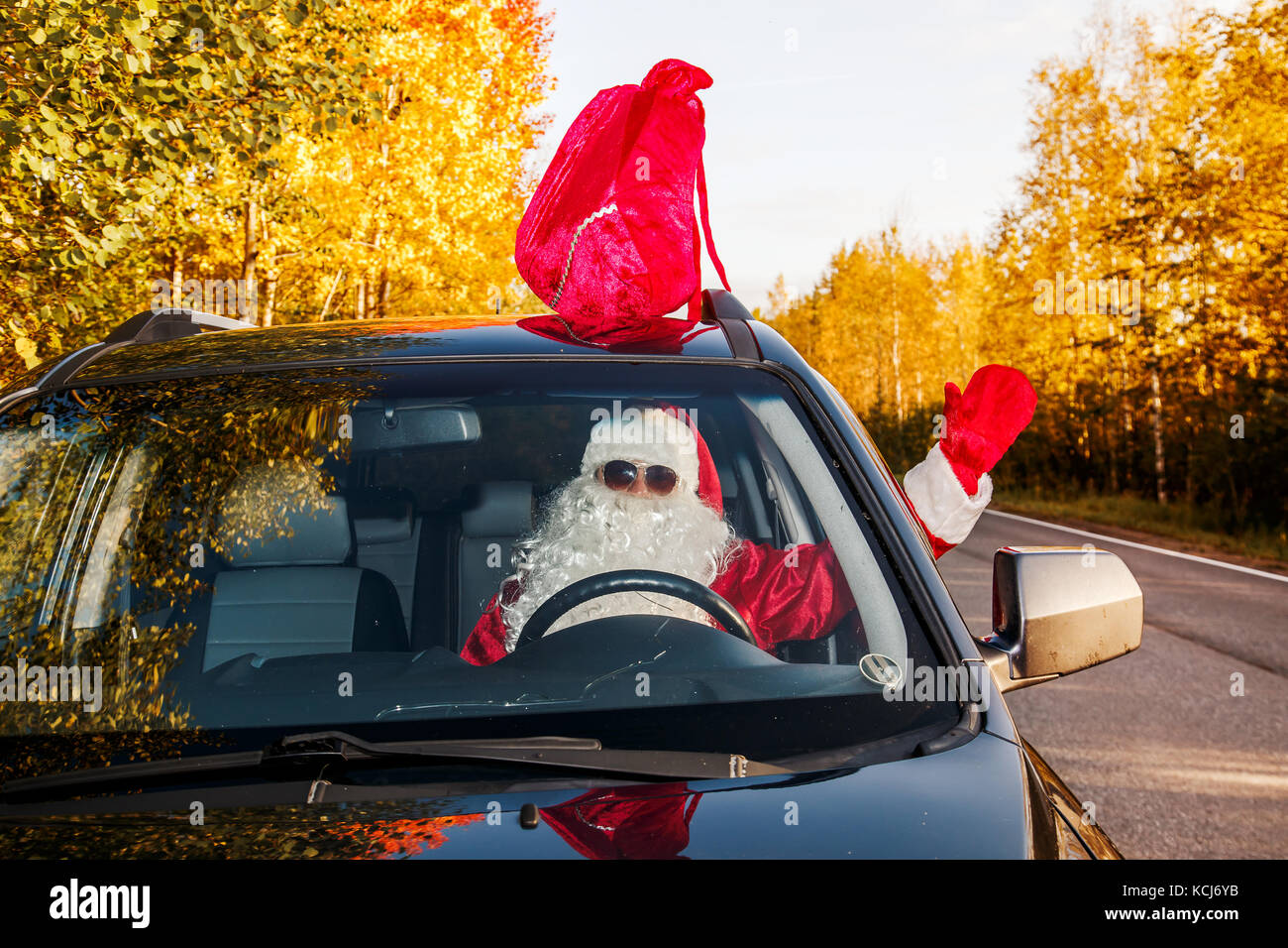 Authentic Santa Claus. Santa Claus drives a car through the autumn ...