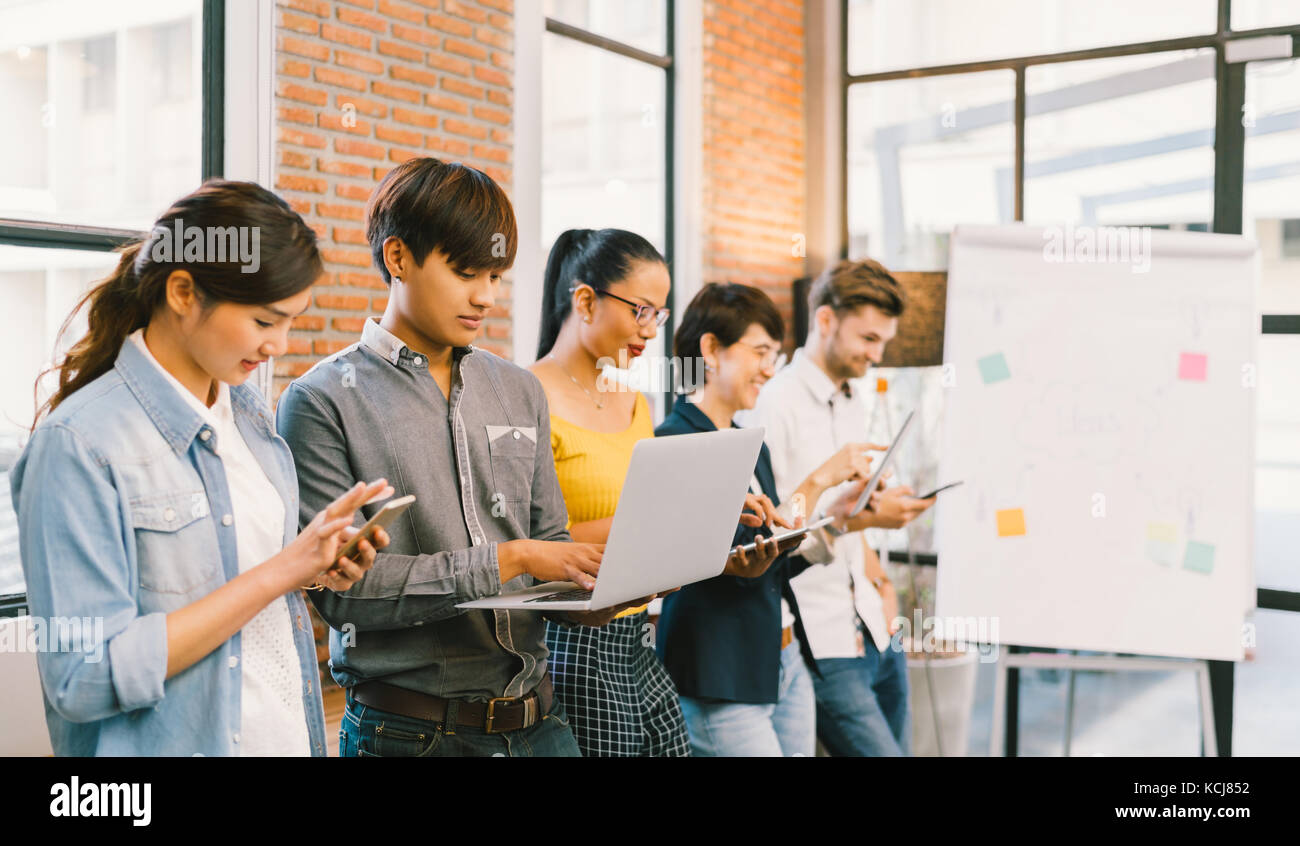 Multiethnic diverse group of happy young adult using information ...