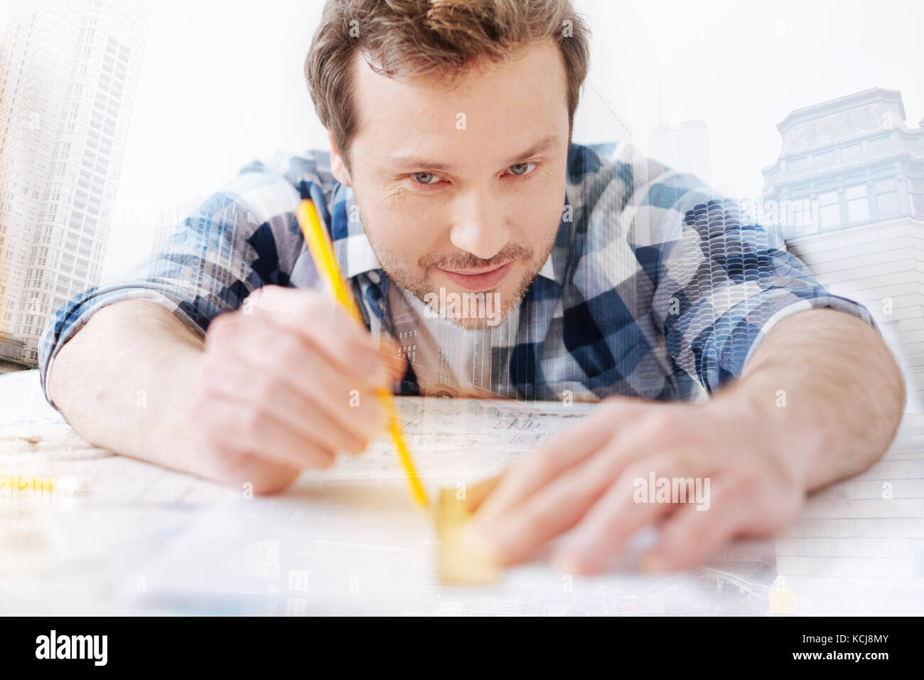 Talented engineer using a pencil and a ruler Stock Photo - Alamy