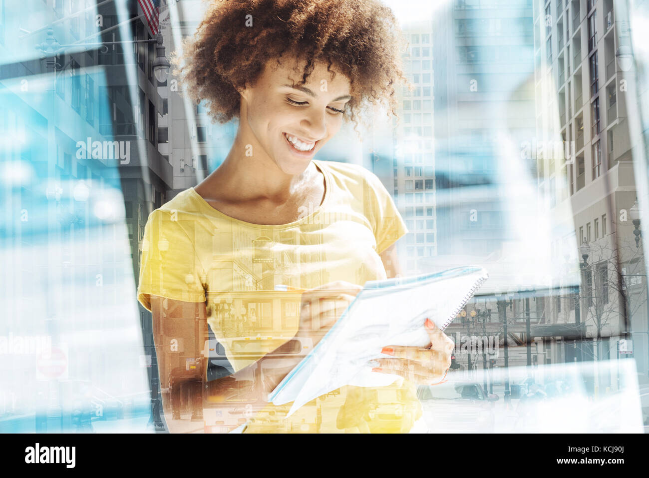 Busy smiling girl writing down the notes Stock Photo - Alamy