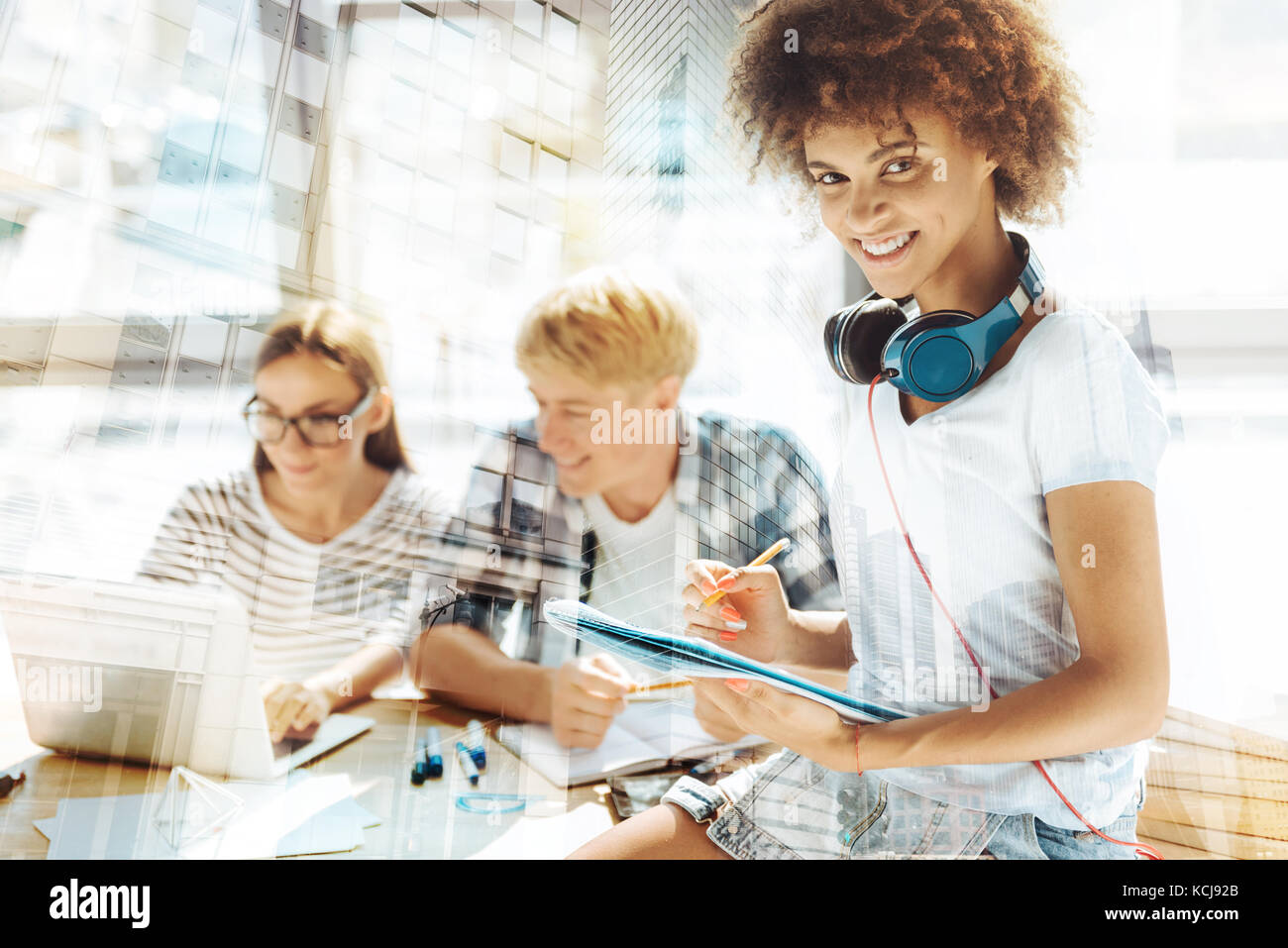 Smiling girl holding notes in hands Stock Photo - Alamy