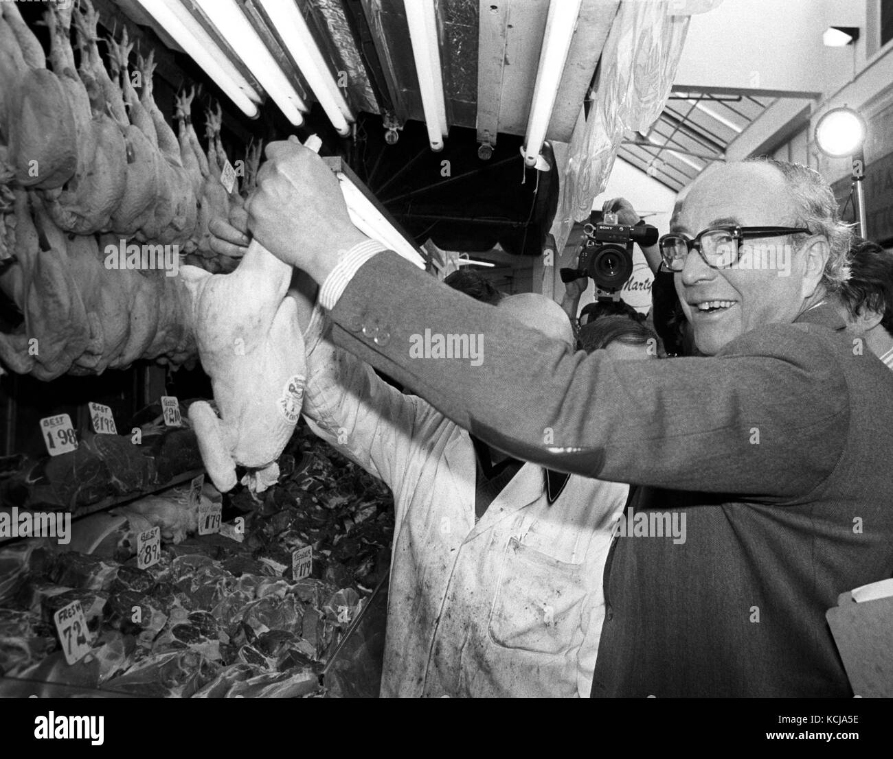 SDP leader Roy Jenkins at a meat stall in Brixton Market during his ...