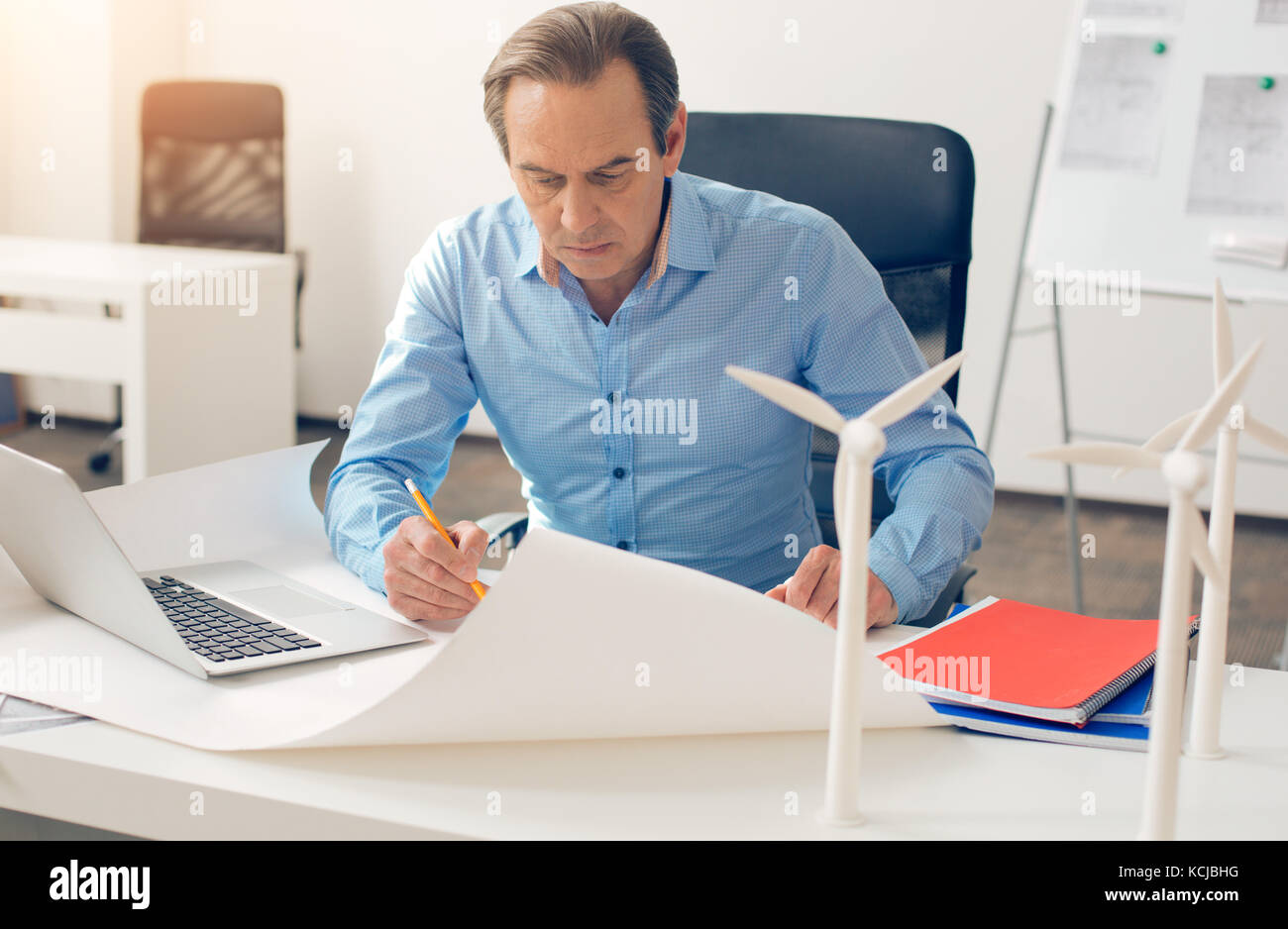 Handsome male engineer working in his office Stock Photo - Alamy