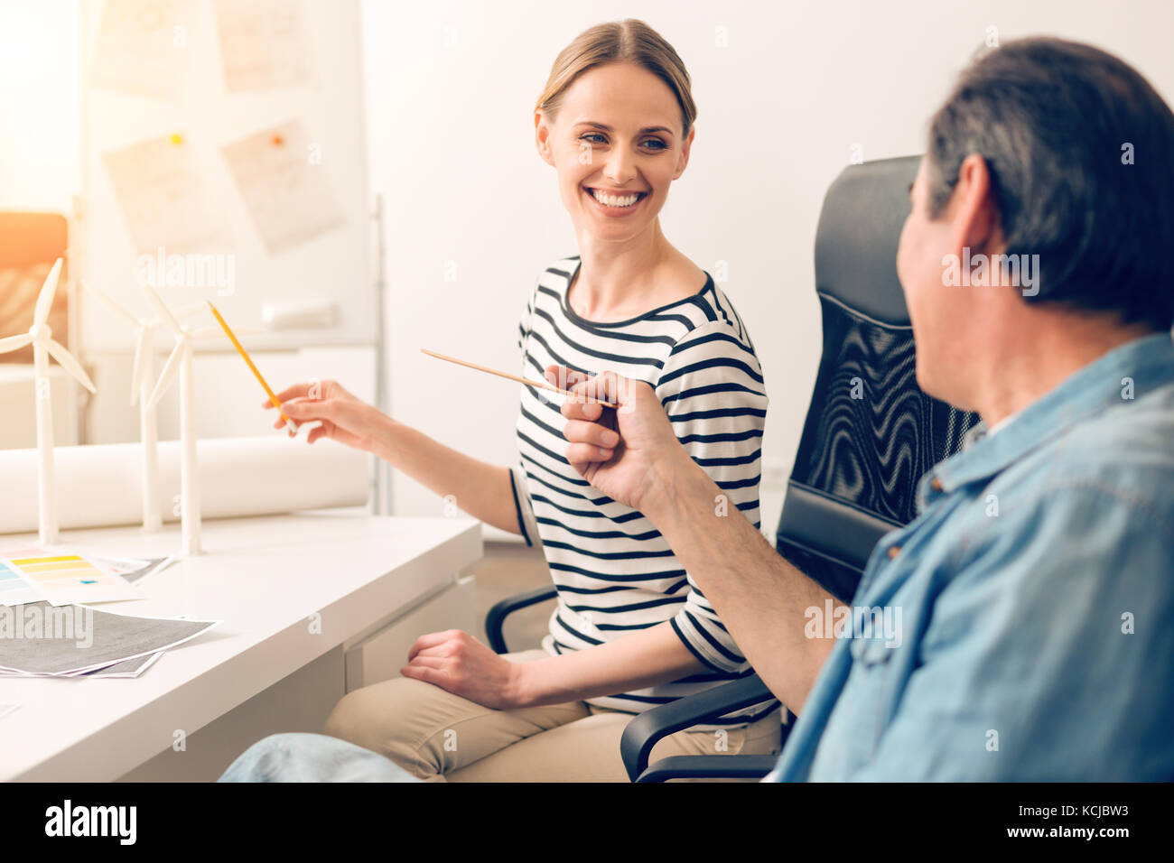 Cheerful smart engineers talking to each other Stock Photo - Alamy