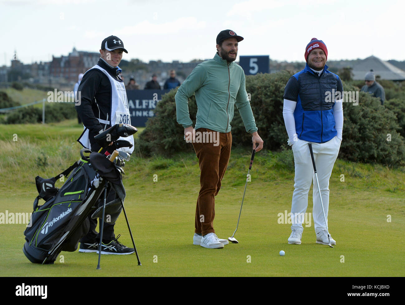Jamie Dornan (centre) and England's Tyrell Hatton (right) during day ...