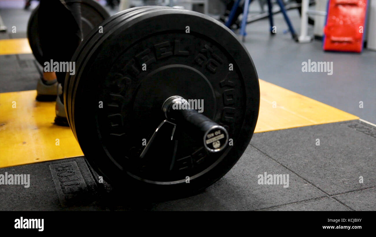 Close up view of barbell on floor in gym. Barbell falls to the floor ...