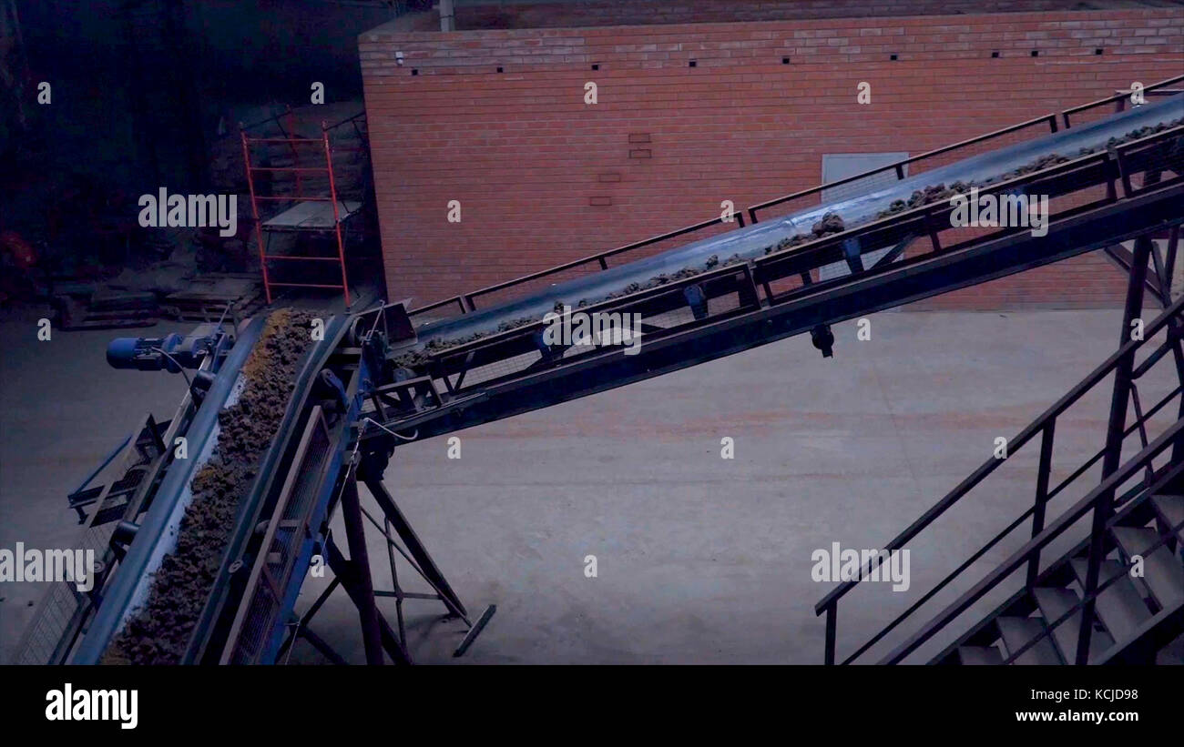 Industrial belt conveyor. Moving Raw Materials. Long conveyor belt ...