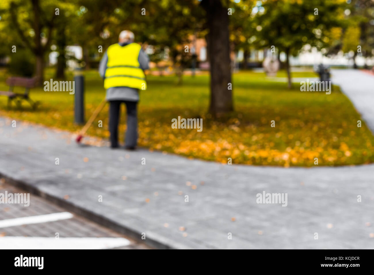 Abstract blurred background - road sweeper worker cleaning city street ...