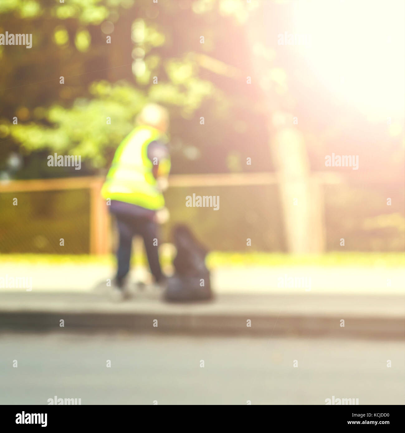 Abstract blurred background - road sweeper worker cleaning city street ...