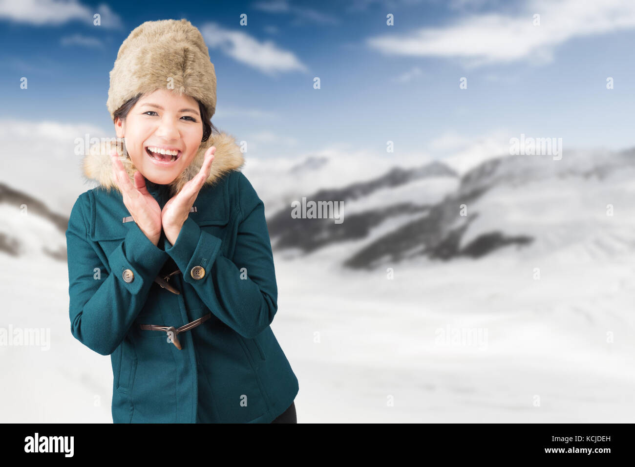 asian tourist wearing green coat with snow mountain background Stock ...