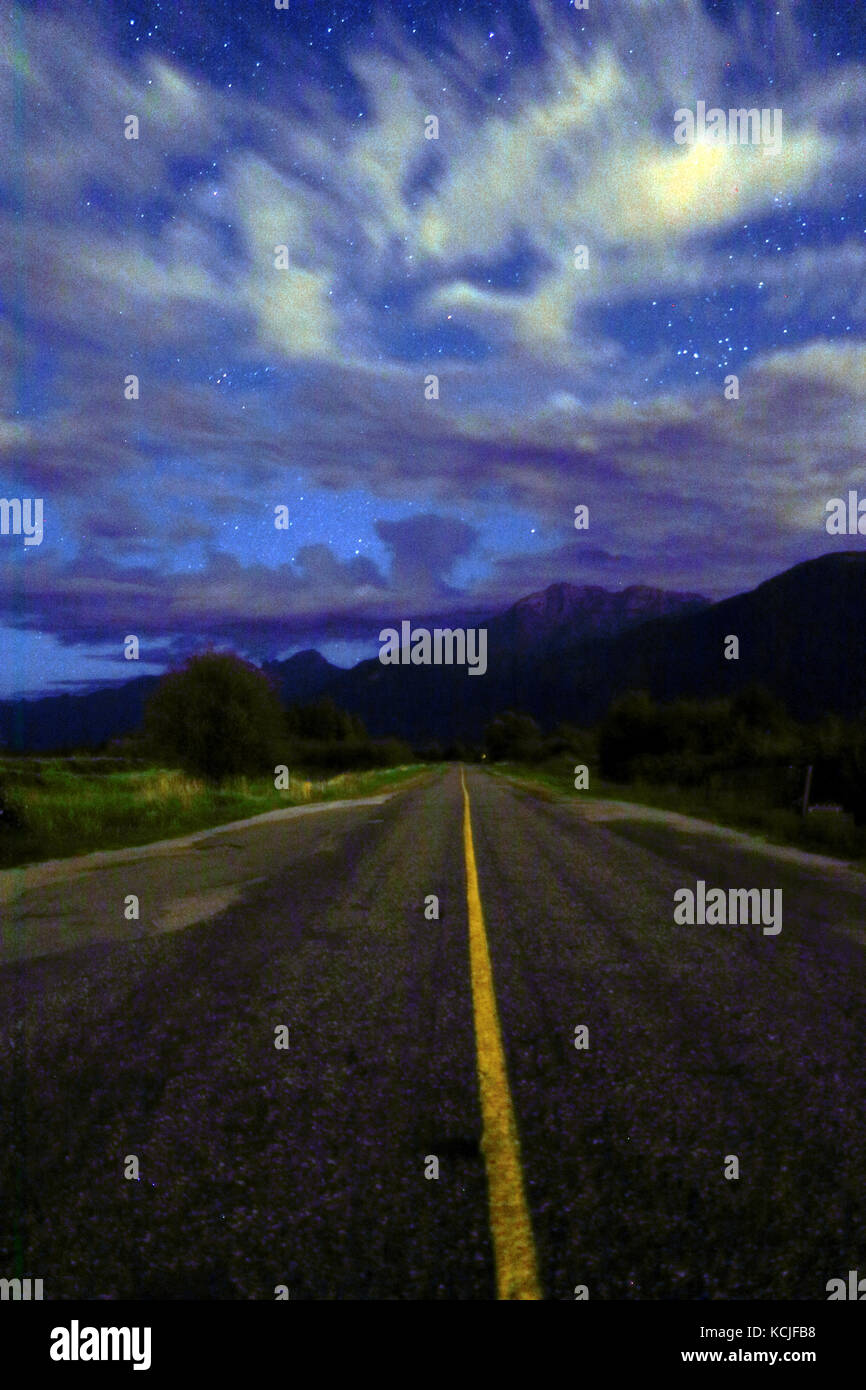 On the road at night Stock Photo - Alamy