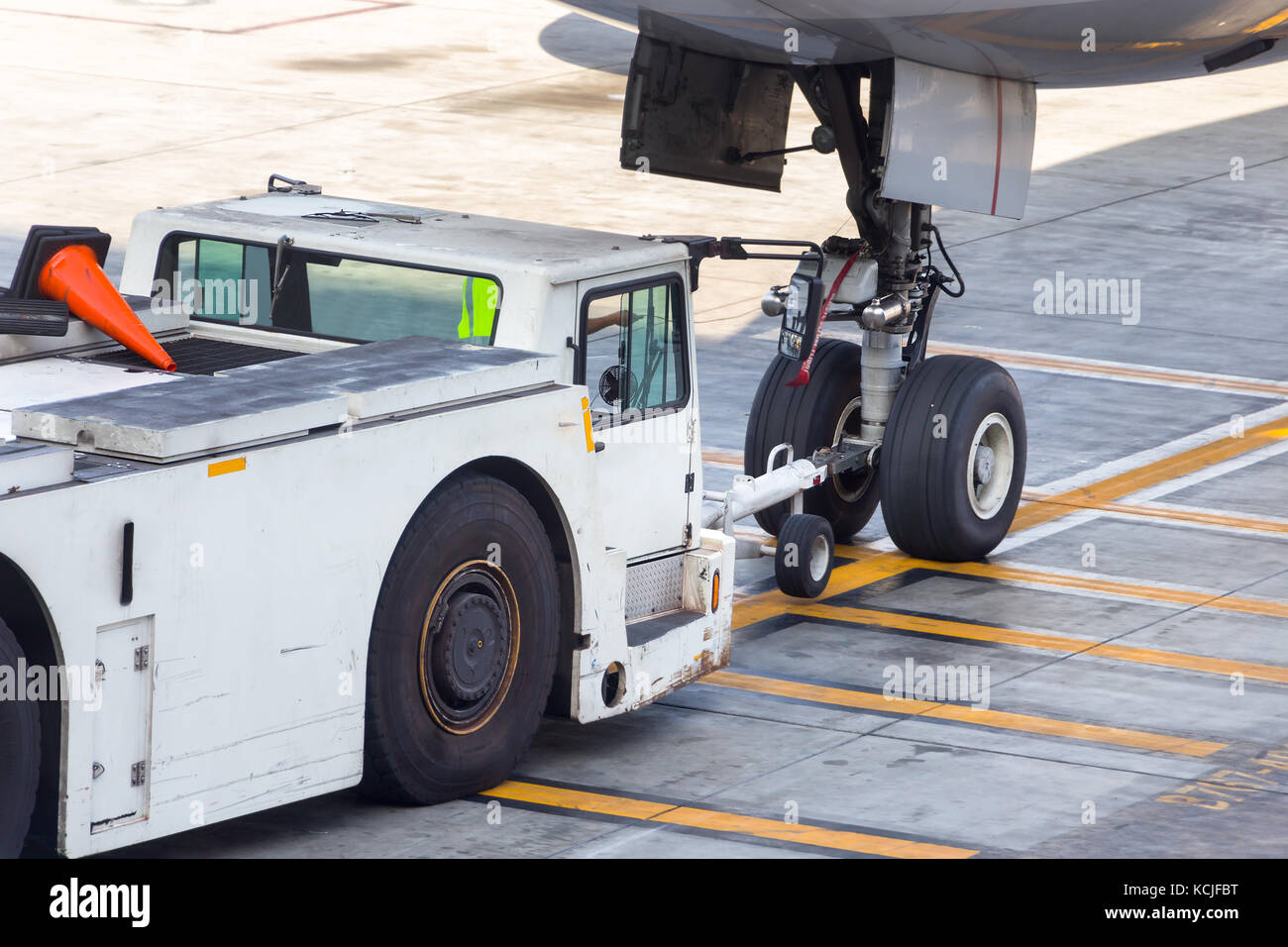 An aircraft tow truck is connected to the tug of the nose landing Stock Photo: 162676412 - Alamy