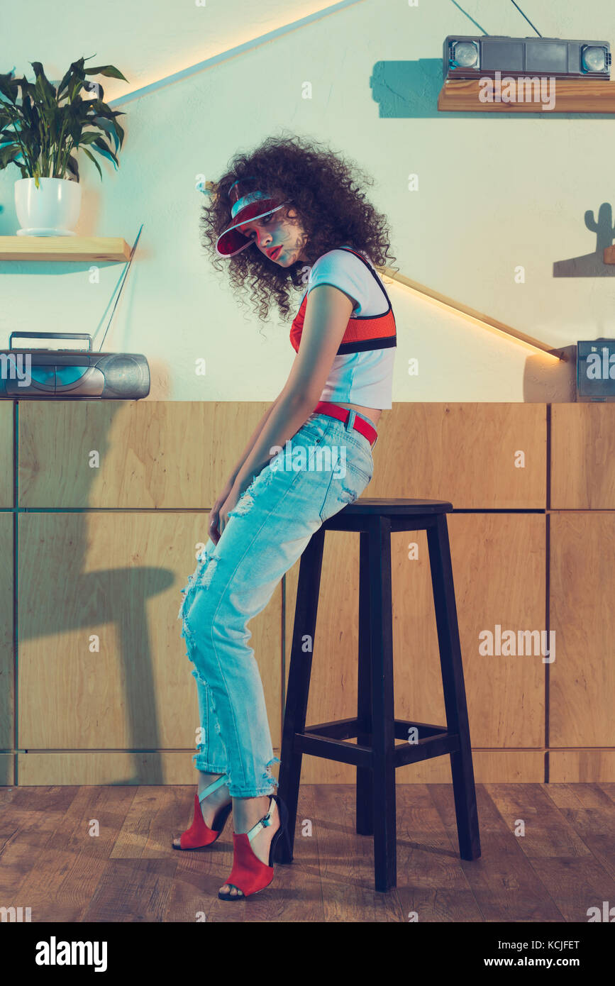 fashionable woman sitting on bar stool Stock Photo - Alamy