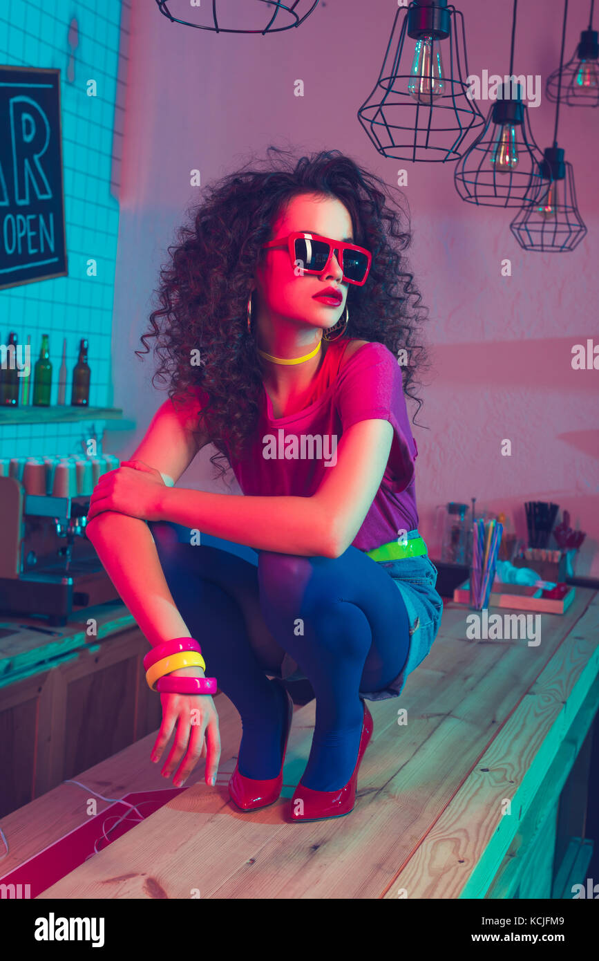 stylish woman sitting on counter Stock Photo - Alamy