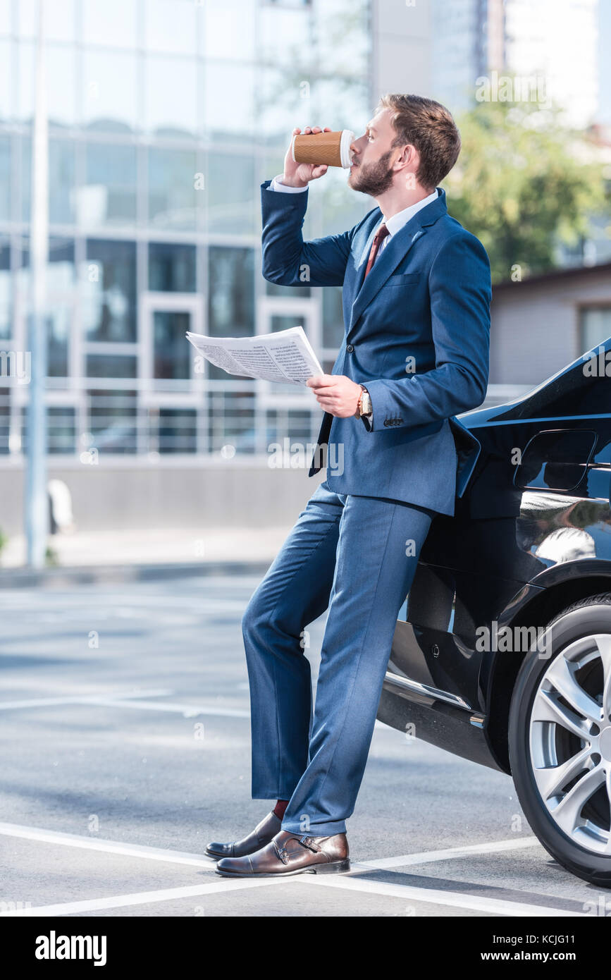 businessman drinking coffee at car Stock Photo - Alamy