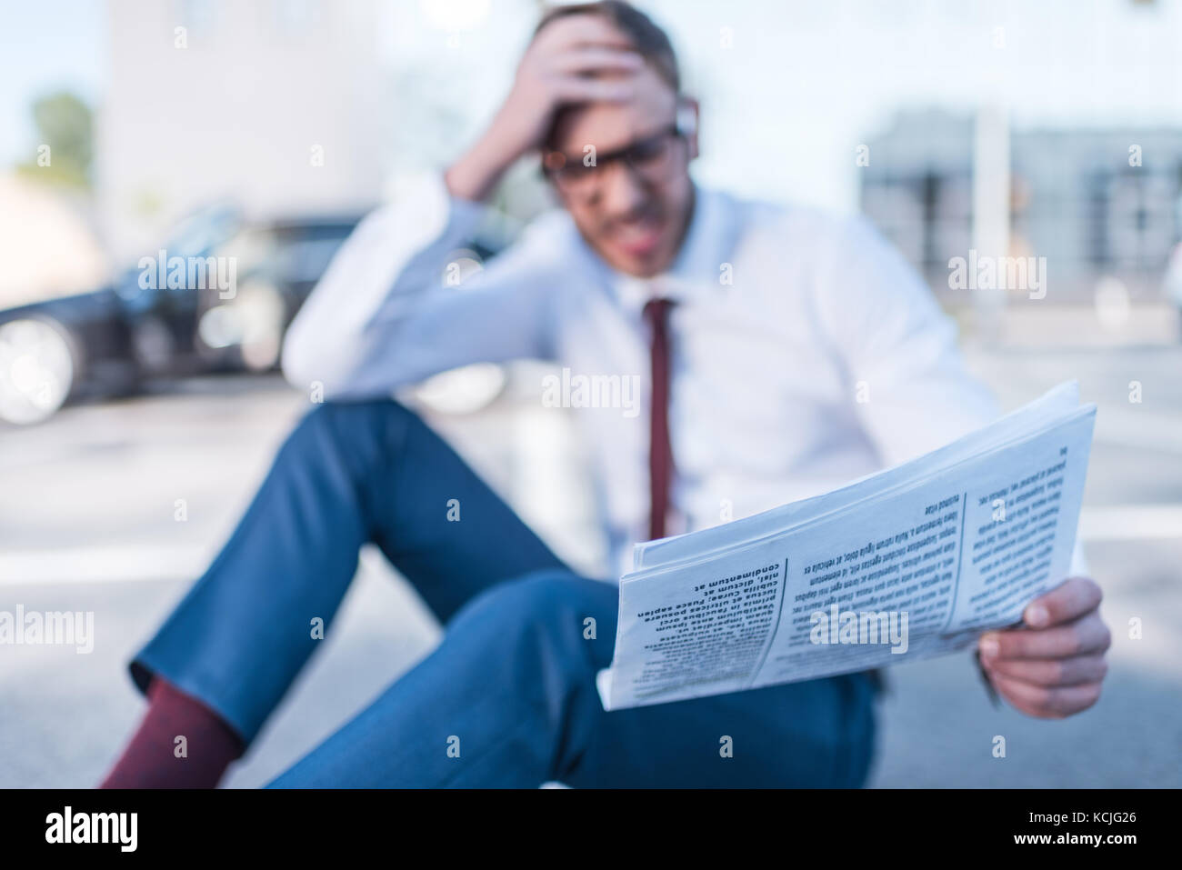 stressed businessman with newspaper Stock Photo - Alamy